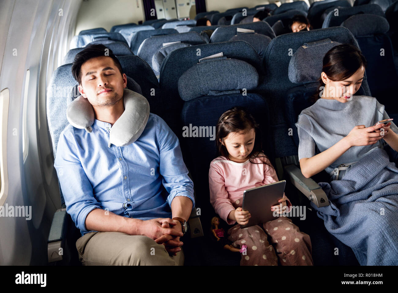 Happy families by plane Stock Photo - Alamy