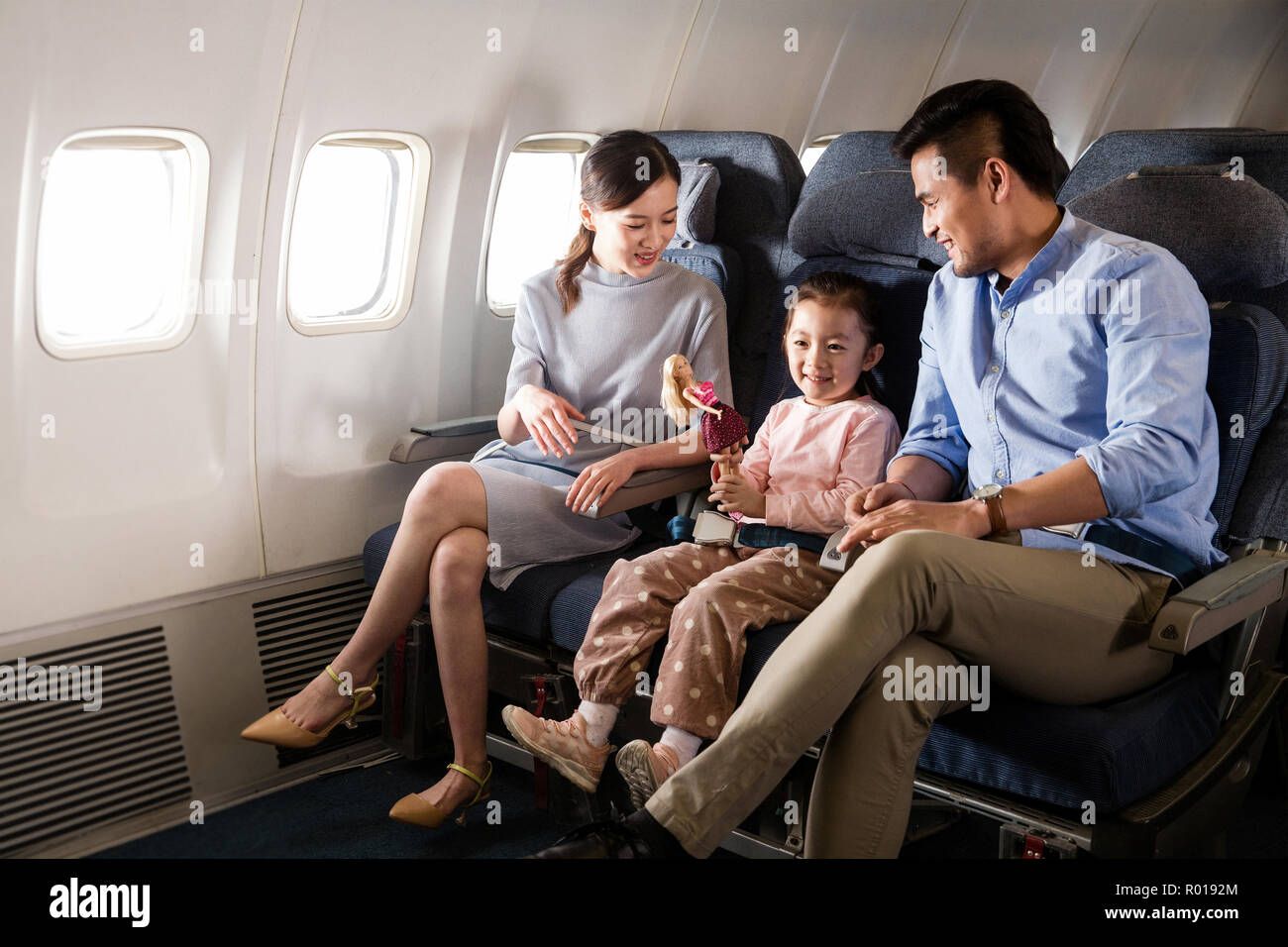 Happy families by plane Stock Photo - Alamy