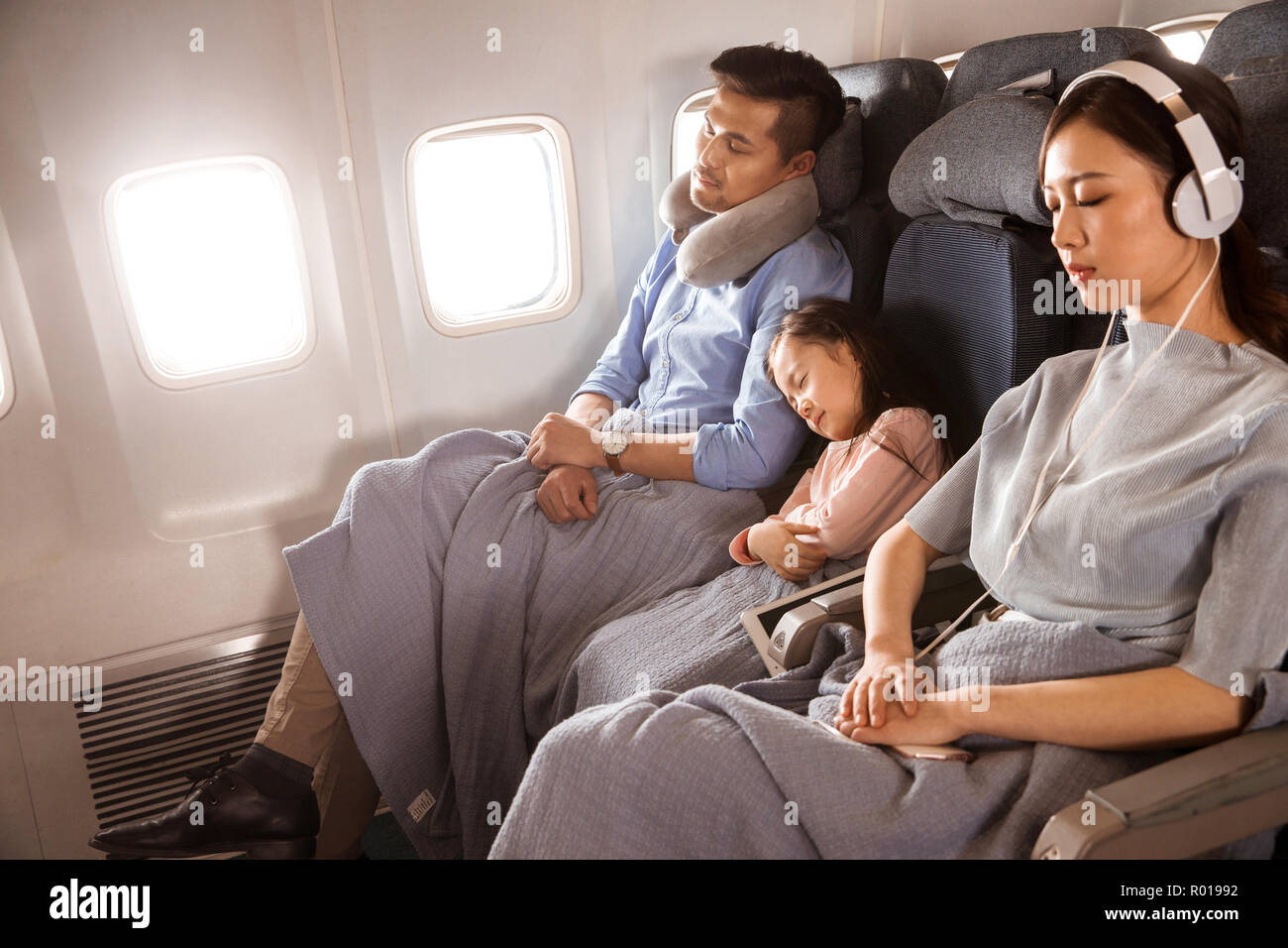 Happy families by plane Stock Photo - Alamy