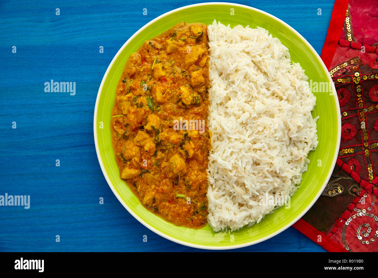 Chicken curry dish indian recipe on blue table Stock Photo - Alamy