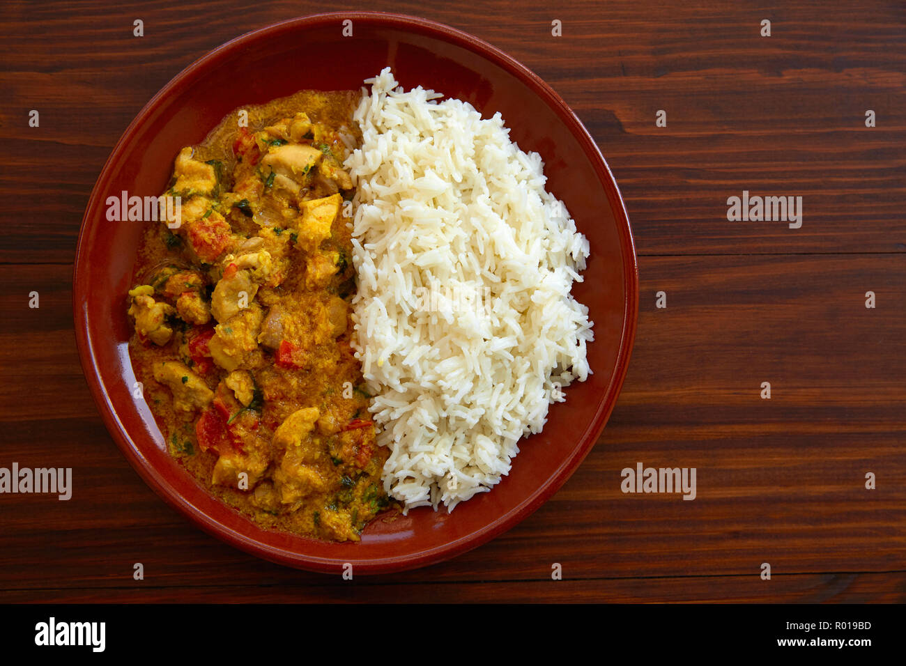 Chicken curry dish indian recipe on dark wood table Stock Photo - Alamy