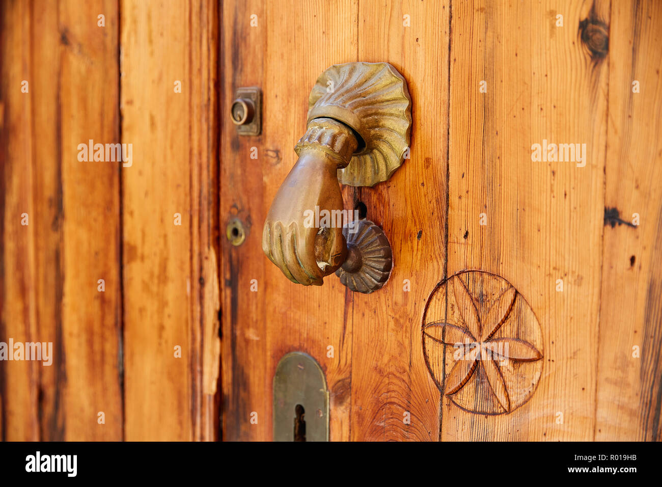 Door brass knock hand shape in Mediterranean Spain Stock Photo - Alamy