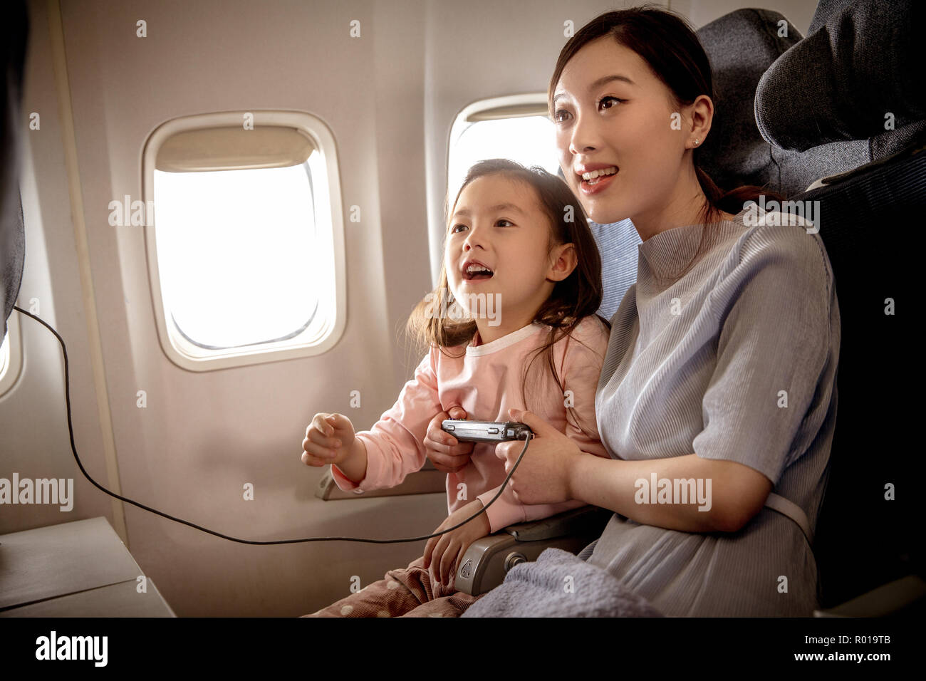 Happy family travel by plane Stock Photo - Alamy