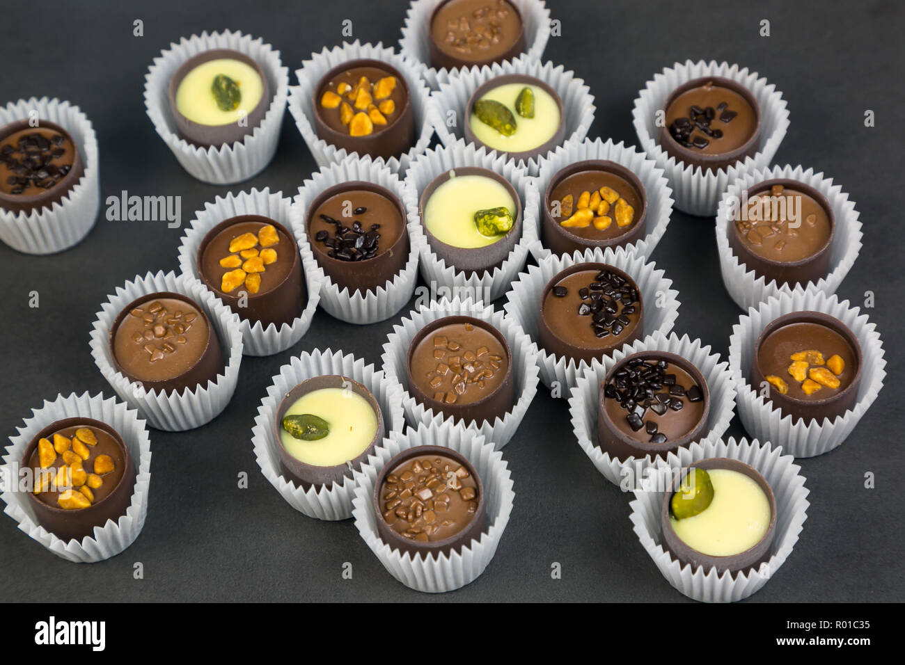 Chocolate candies with various fillings in a paper wrapper on a bright ...