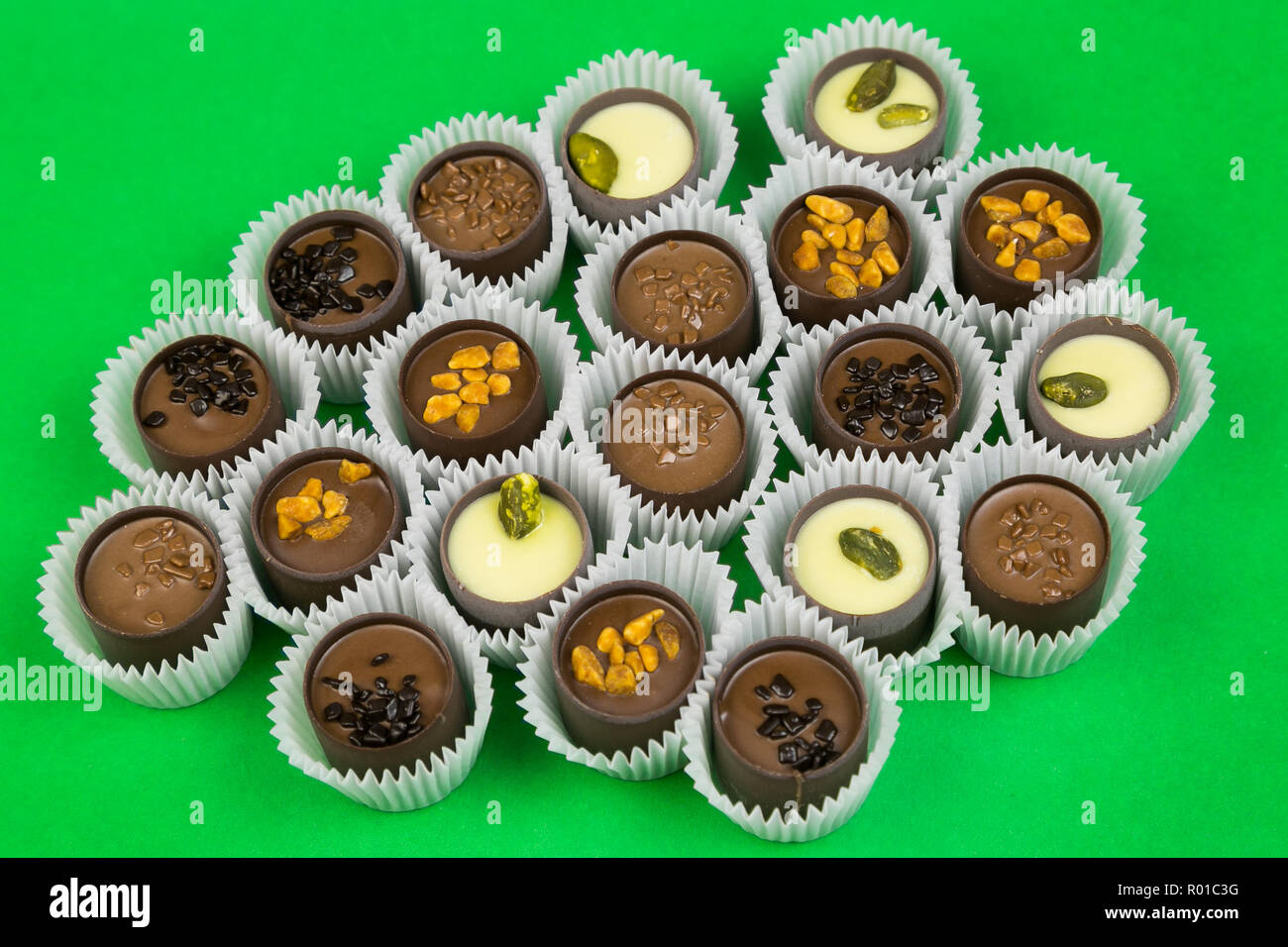 Chocolate candies with various fillings in a paper wrapper on a bright ...