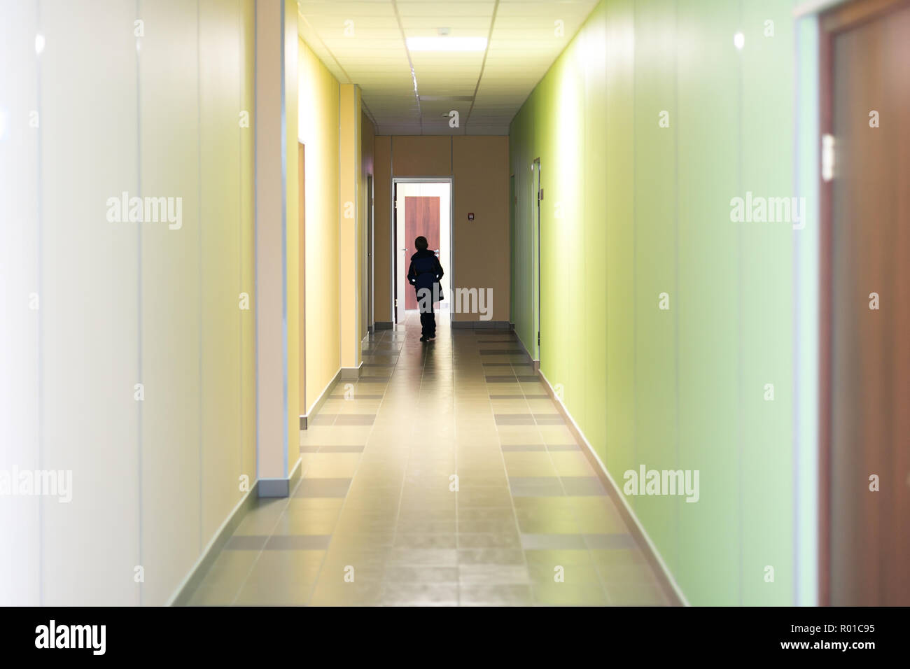 A school age child is walking down the hall Stock Photo - Alamy
