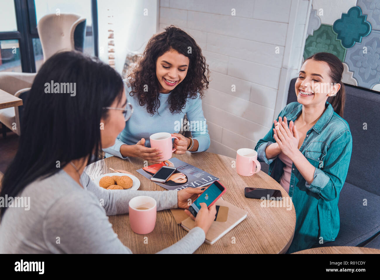Positive nice woman checking the weather forecast Stock Photo - Alamy