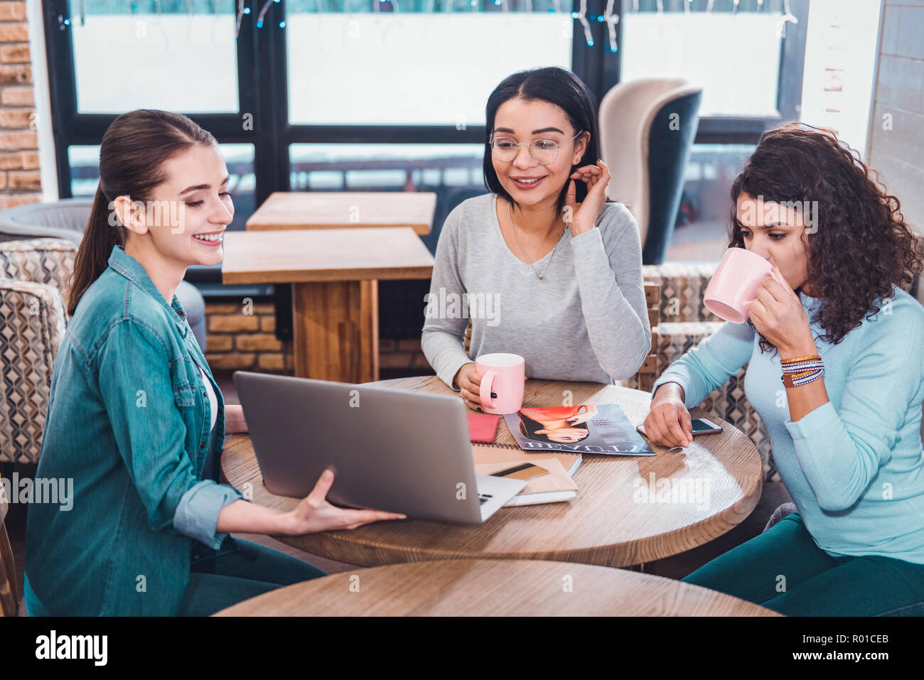 Positive joyful woman presenting her ideas to colleague Stock Photo - Alamy