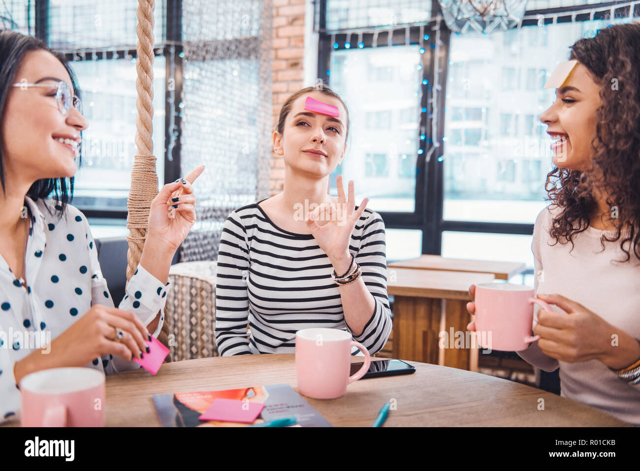 Nice positive woman showing the OK sign Stock Photo - Alamy