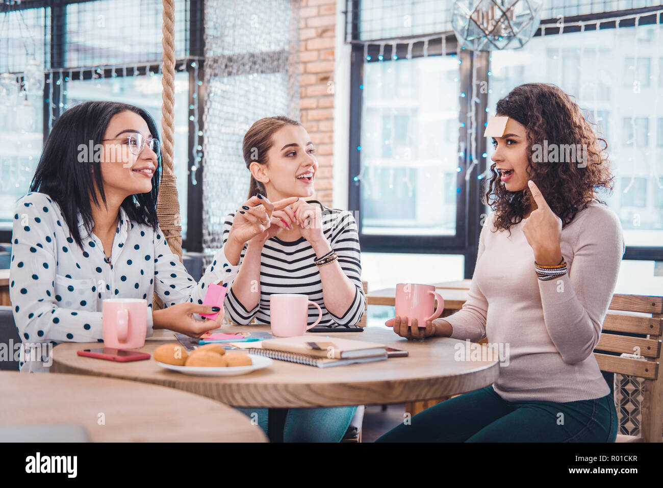 Nice young woman trying to guess her nickname Stock Photo - Alamy