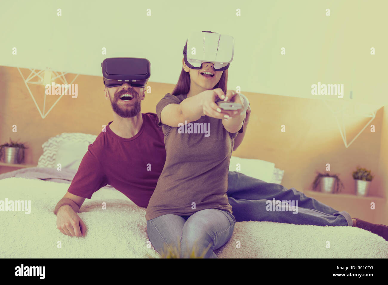 View of womans hand holding TV remote control Stock Photo - Alamy