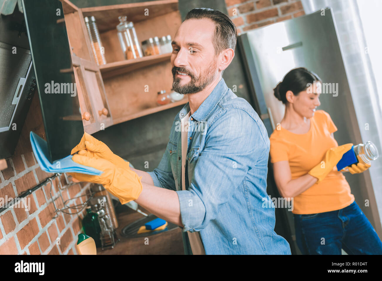 Positive delighted couple cleaning home together Stock Photo - Alamy