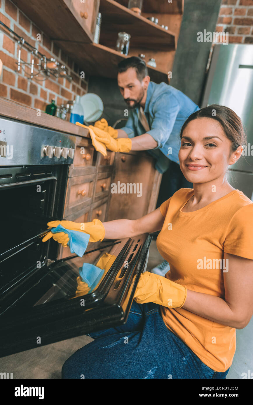 Cheerful female person cleaning her kitchen Stock Photo - Alamy