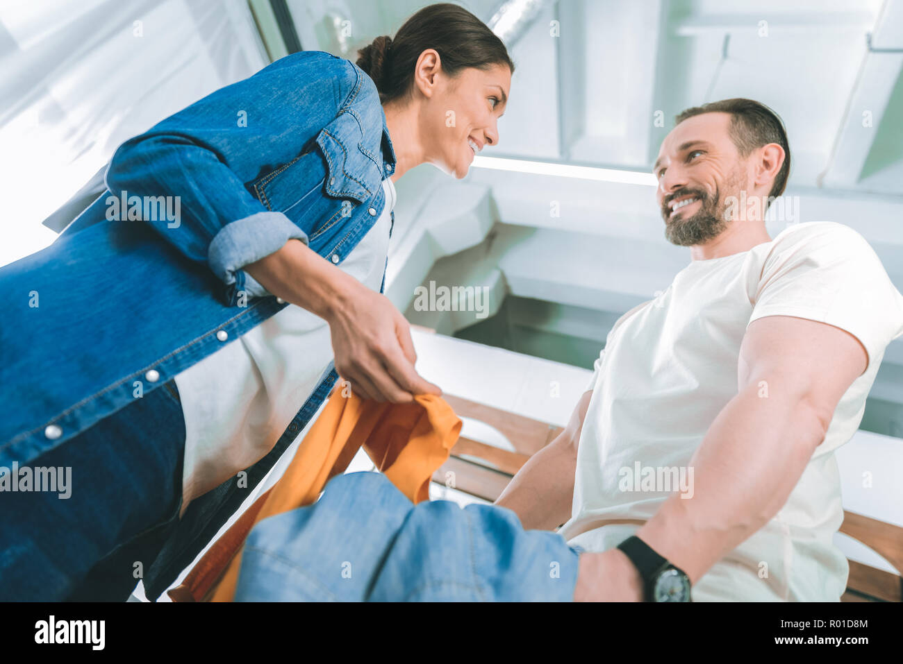 Low angle photo of pleased people while talking Stock Photo - Alamy
