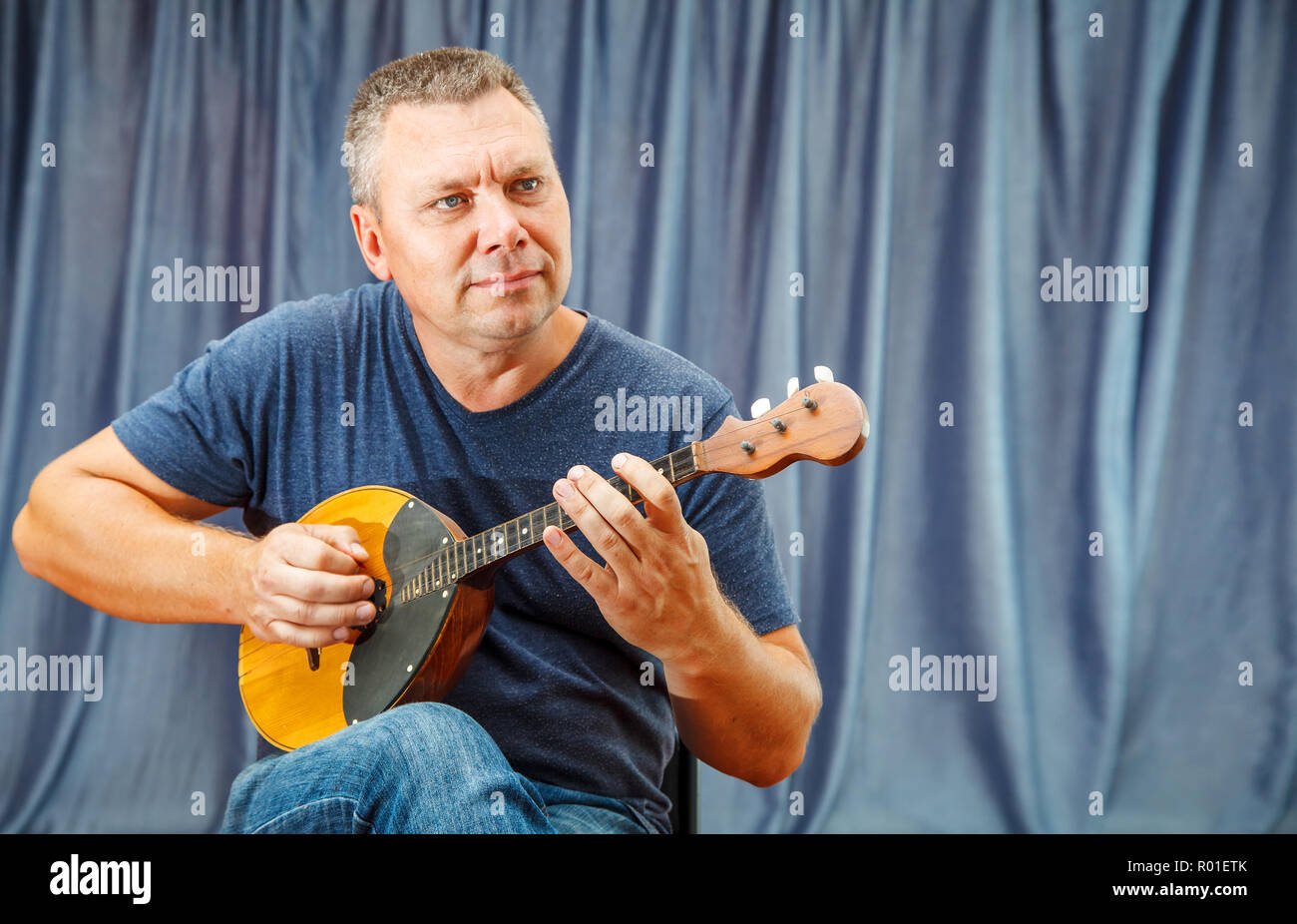 Old man playing strings hi-res stock photography and images - Alamy