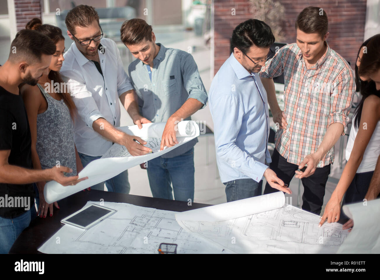 group of designers and architects discussing new sketches Stock Photo ...