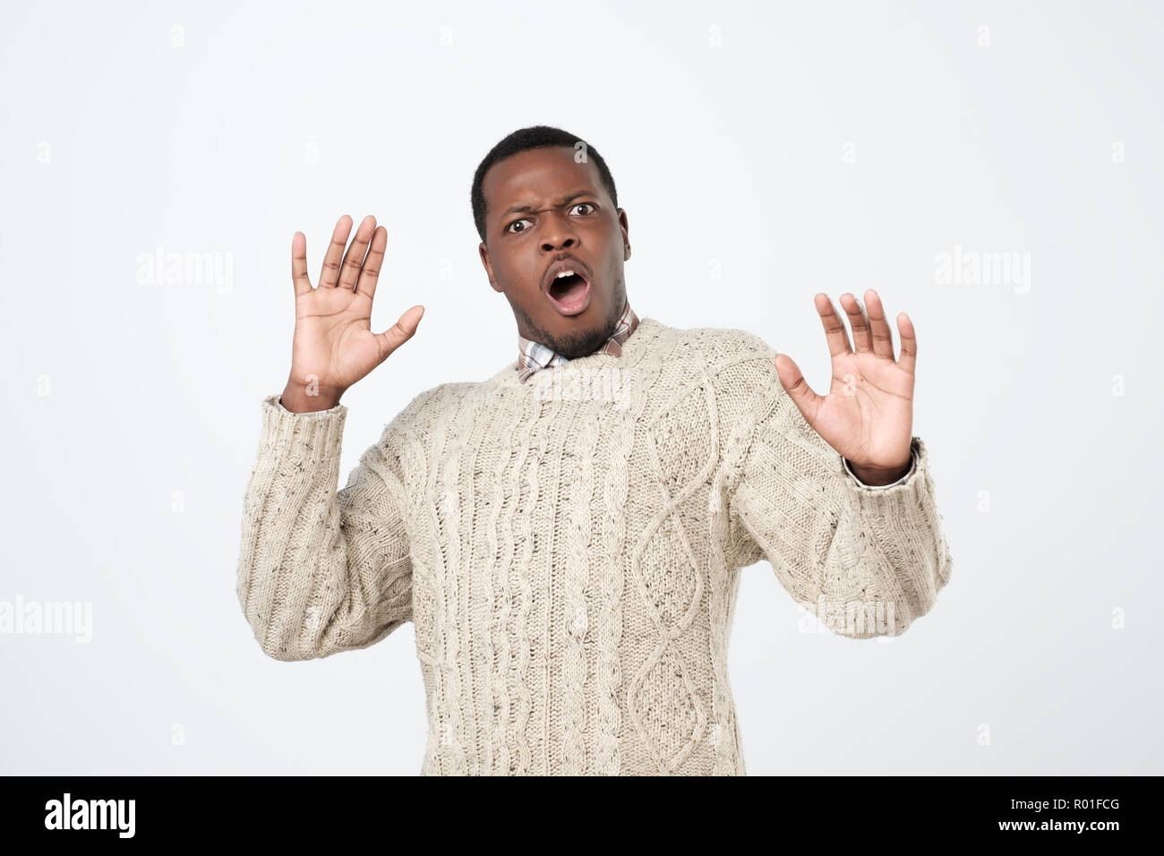 African man looking scared as noticing ghost tilting backwards and ...