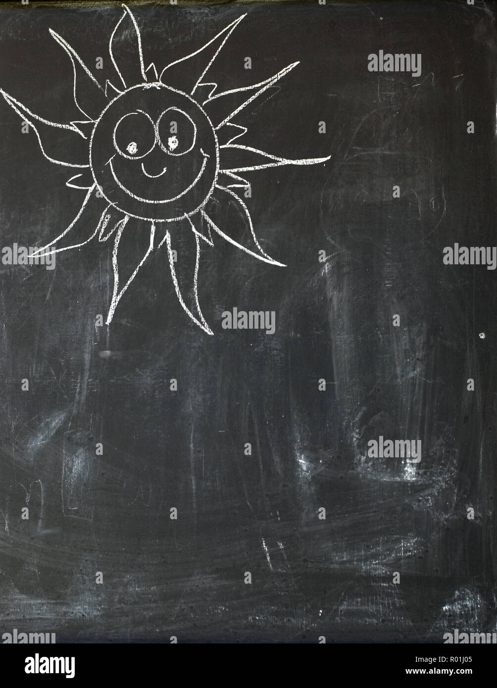 Drawing of a Smiling sun on a School Black Chalkboard Stock Photo - Alamy
