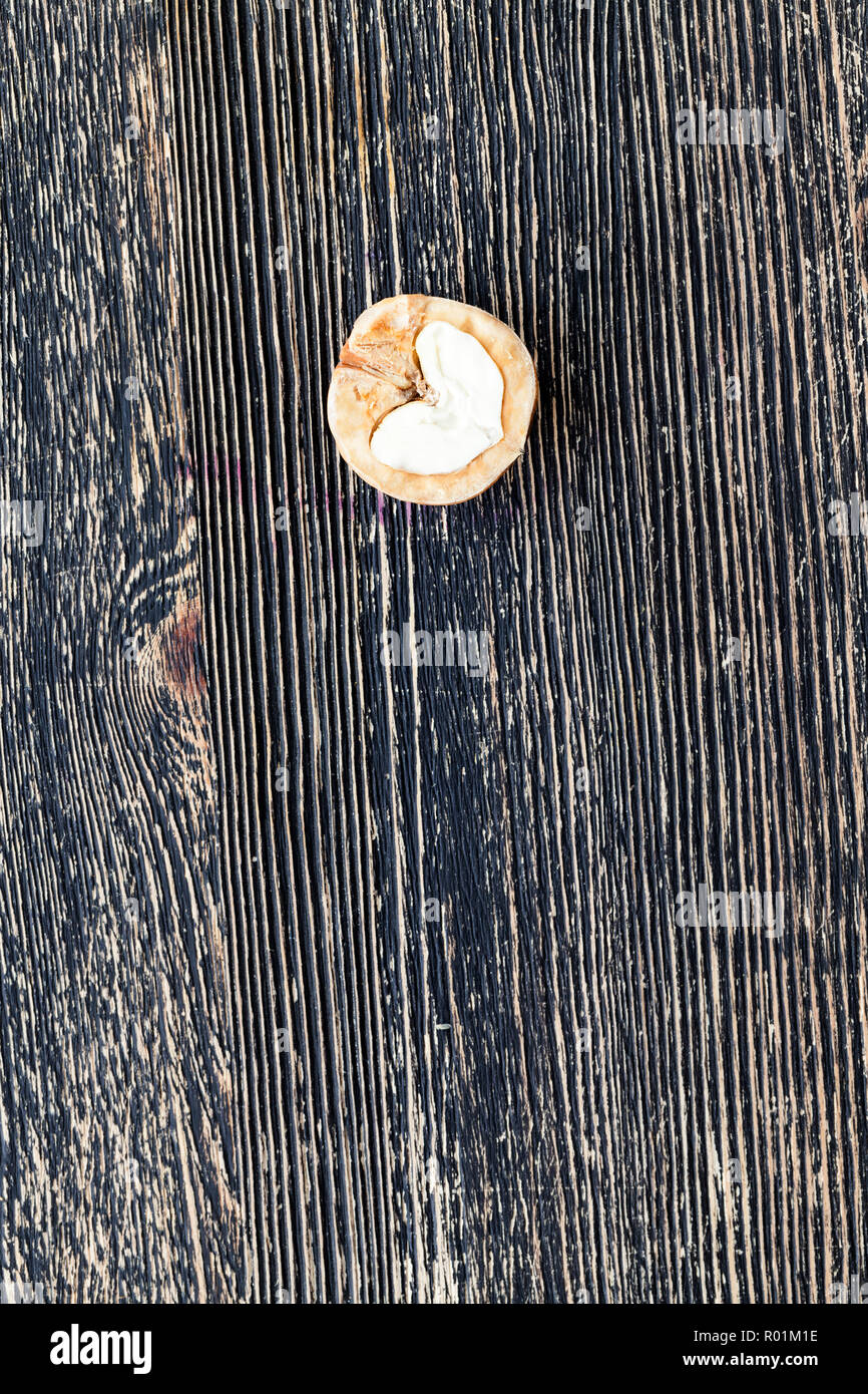 one half broken walnut shell with edible part, closeup from above Stock ...