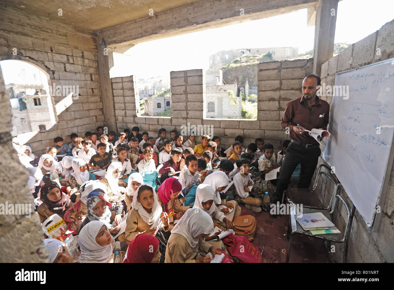 03 October 2018, Yemen, Taiz: Yemeni students sit inside a classroom of ...