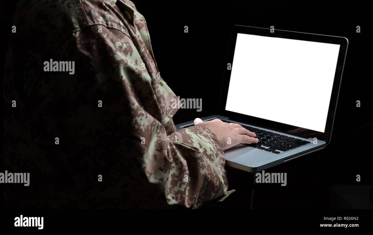 US Army. Young soldier working with a laptop computer with blank screen ...