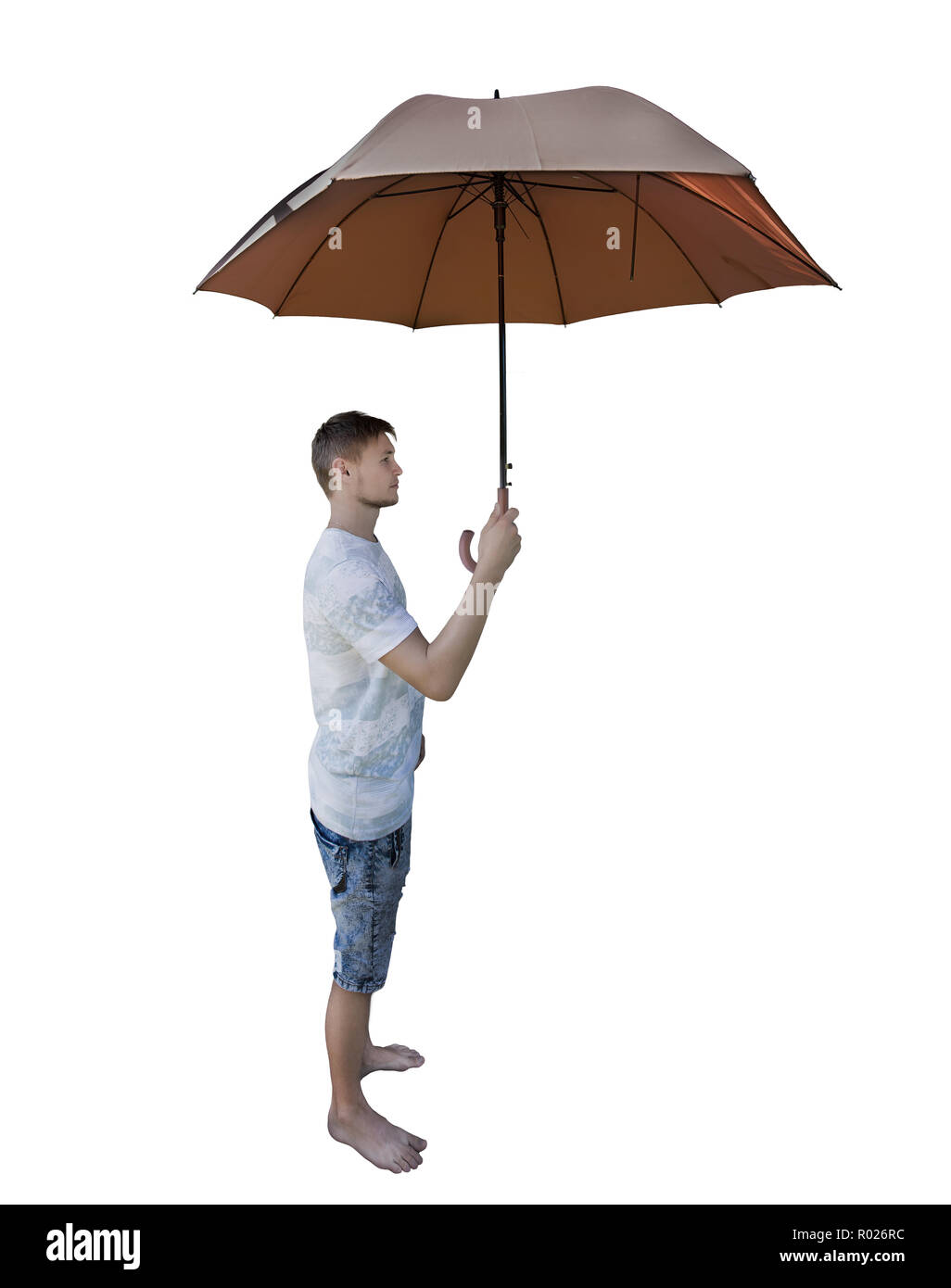 Side view full length portrait of casual young man holding umbrella as ...