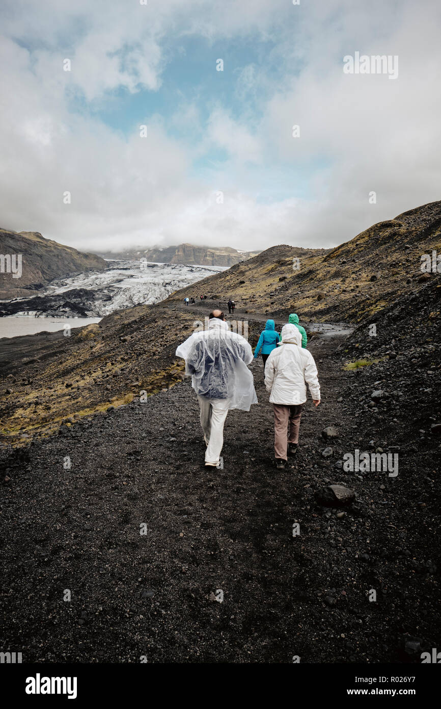Tourists visiting the Sólheimajökull glacier part of the larger ...