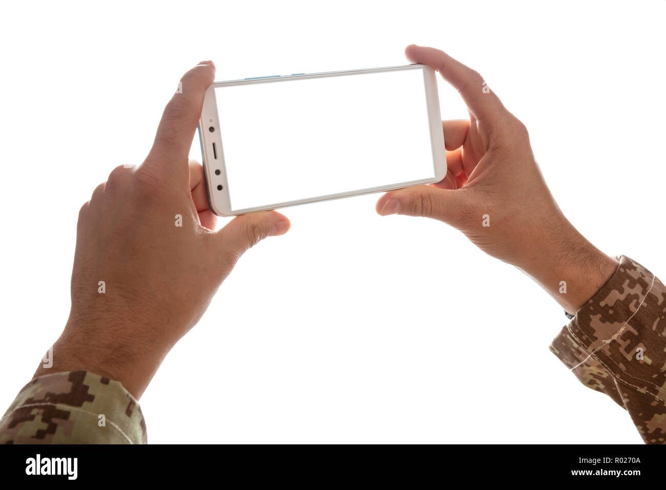US Army. Young soldier holding a mobile phone with blank screen on ...