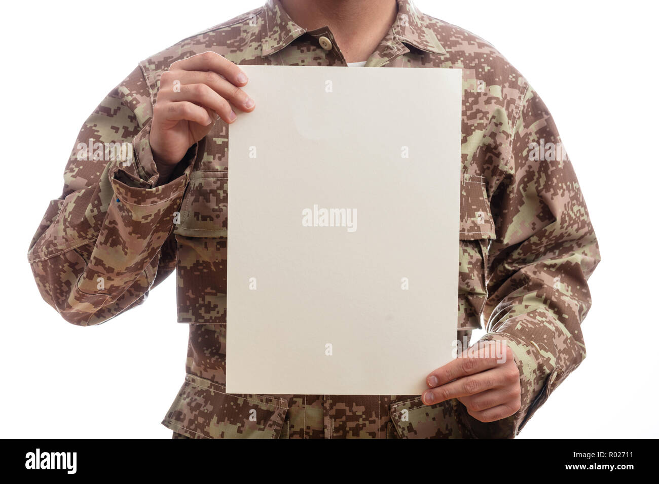US Army. Young soldier holding a blank paper standing on white ...