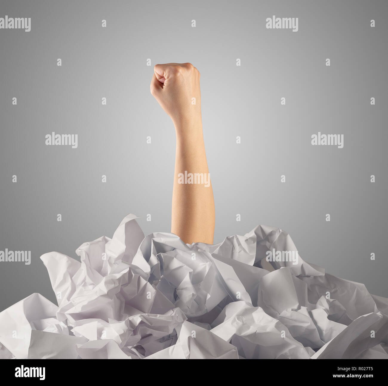 Hand breaking out from pile of paper Stock Photo - Alamy
