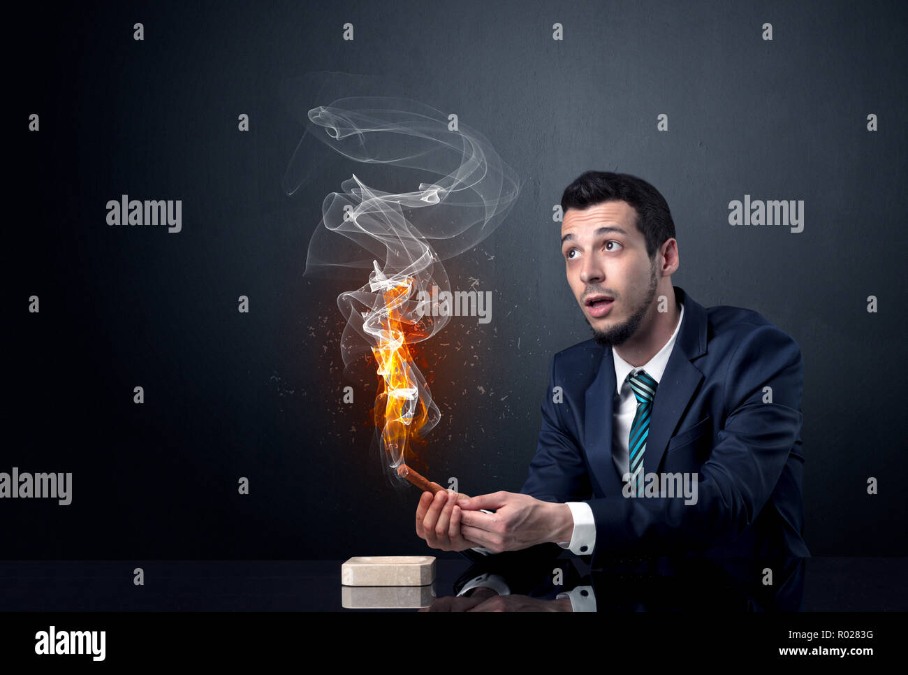 Businessman smoking with inferno effect Stock Photo - Alamy