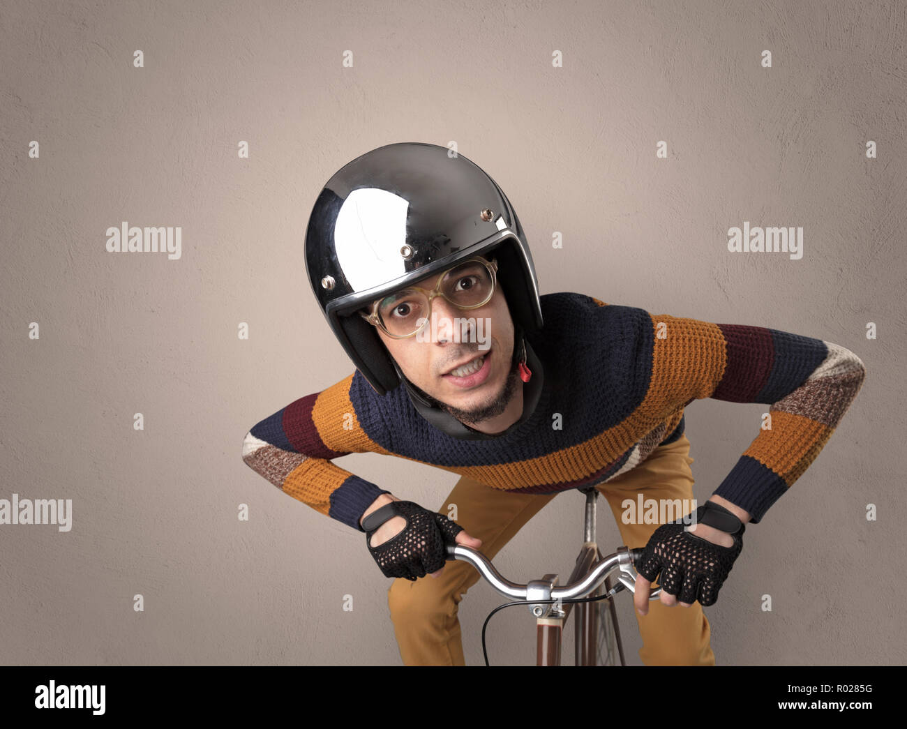 Nerd young foolish biker on a bike with oldschool outfit Stock Photo ...