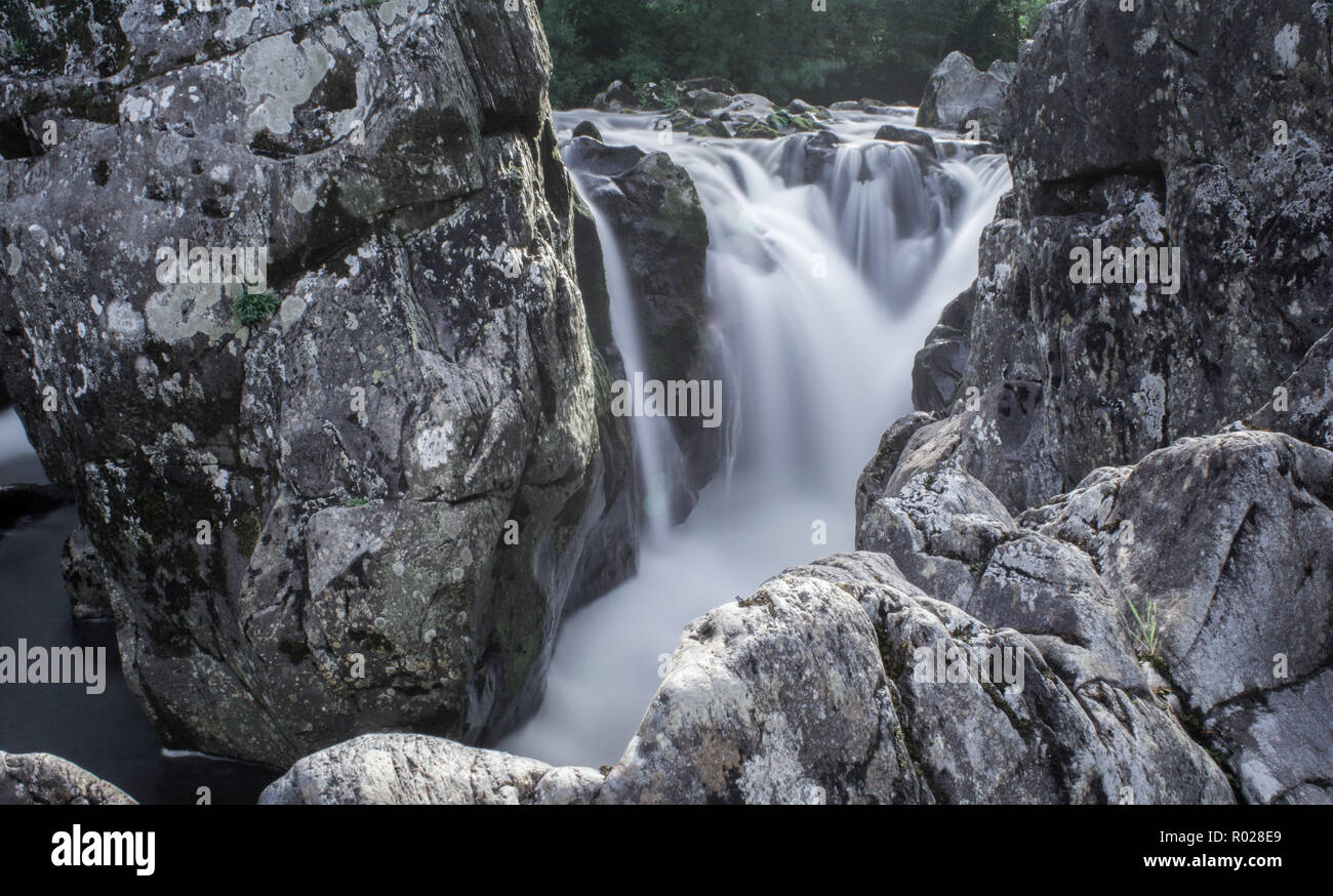 Smooth water flowing down welsh rock in betws y coed Stock Photo - Alamy