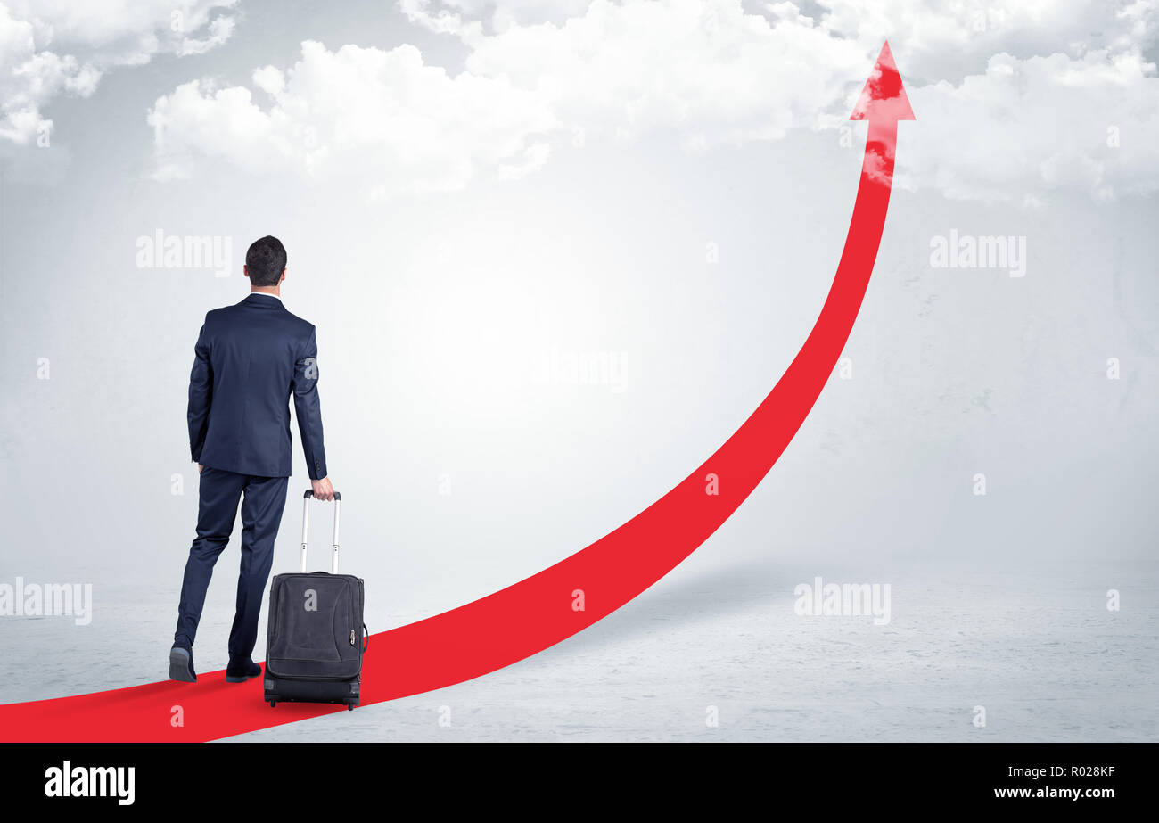 Young businessman with back leaving on the red arrow carpet to the ...