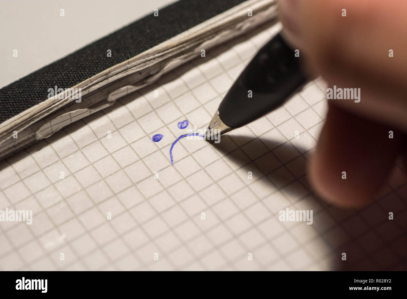 human hand drawing smiley on notepad Stock Photo - Alamy