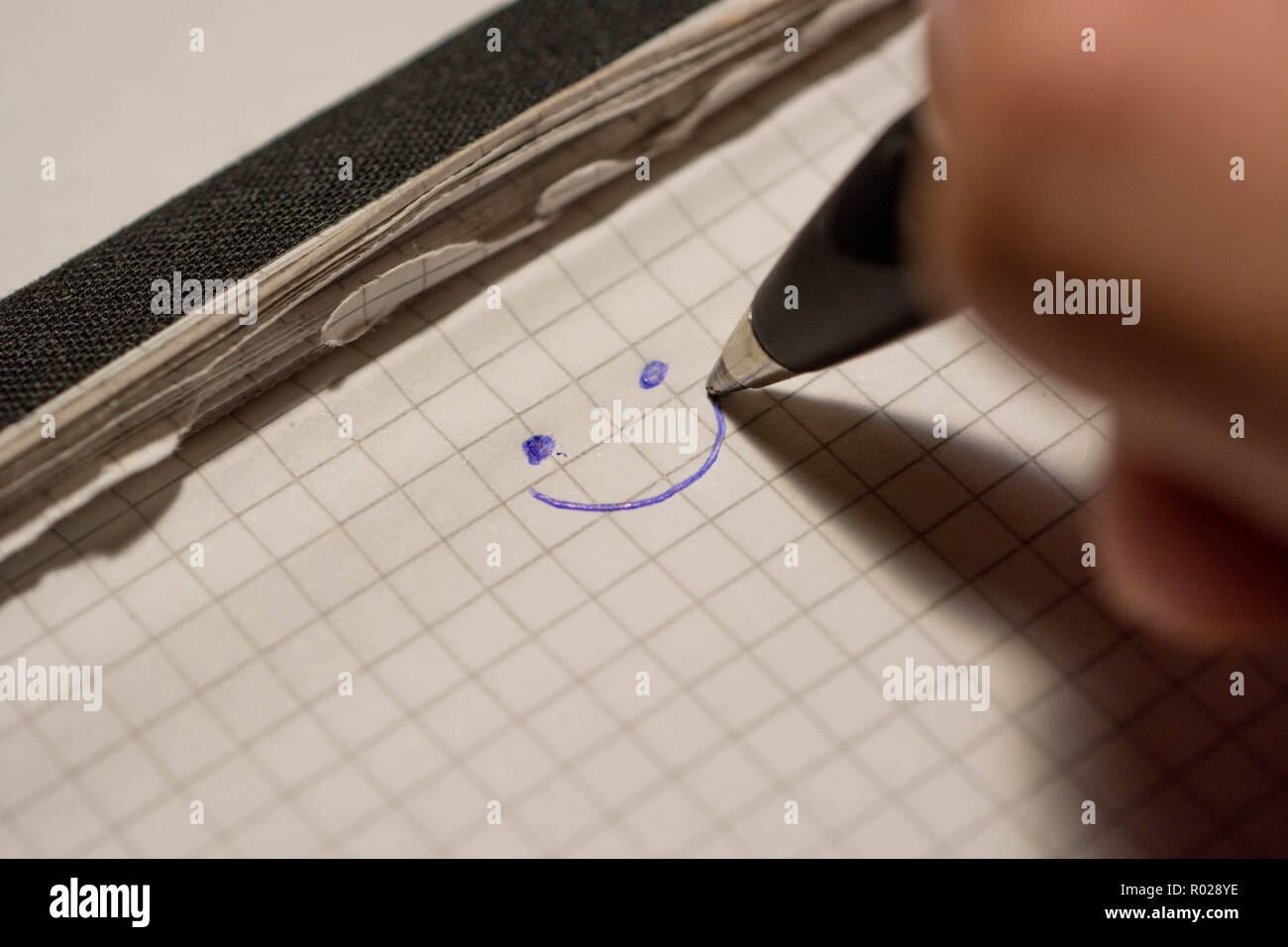 human hand drawing smiley on notepad Stock Photo - Alamy