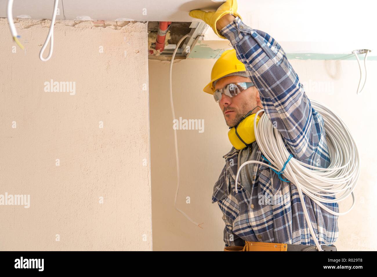 Caucasian Electrician with Cable. Electric Cables Installer ...