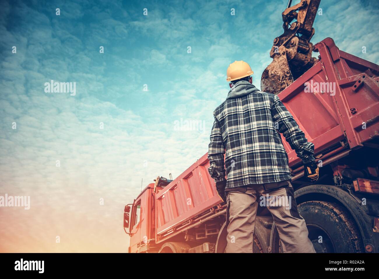 Ground Works Operation. Construction Worker in Front of Dump Truck ...