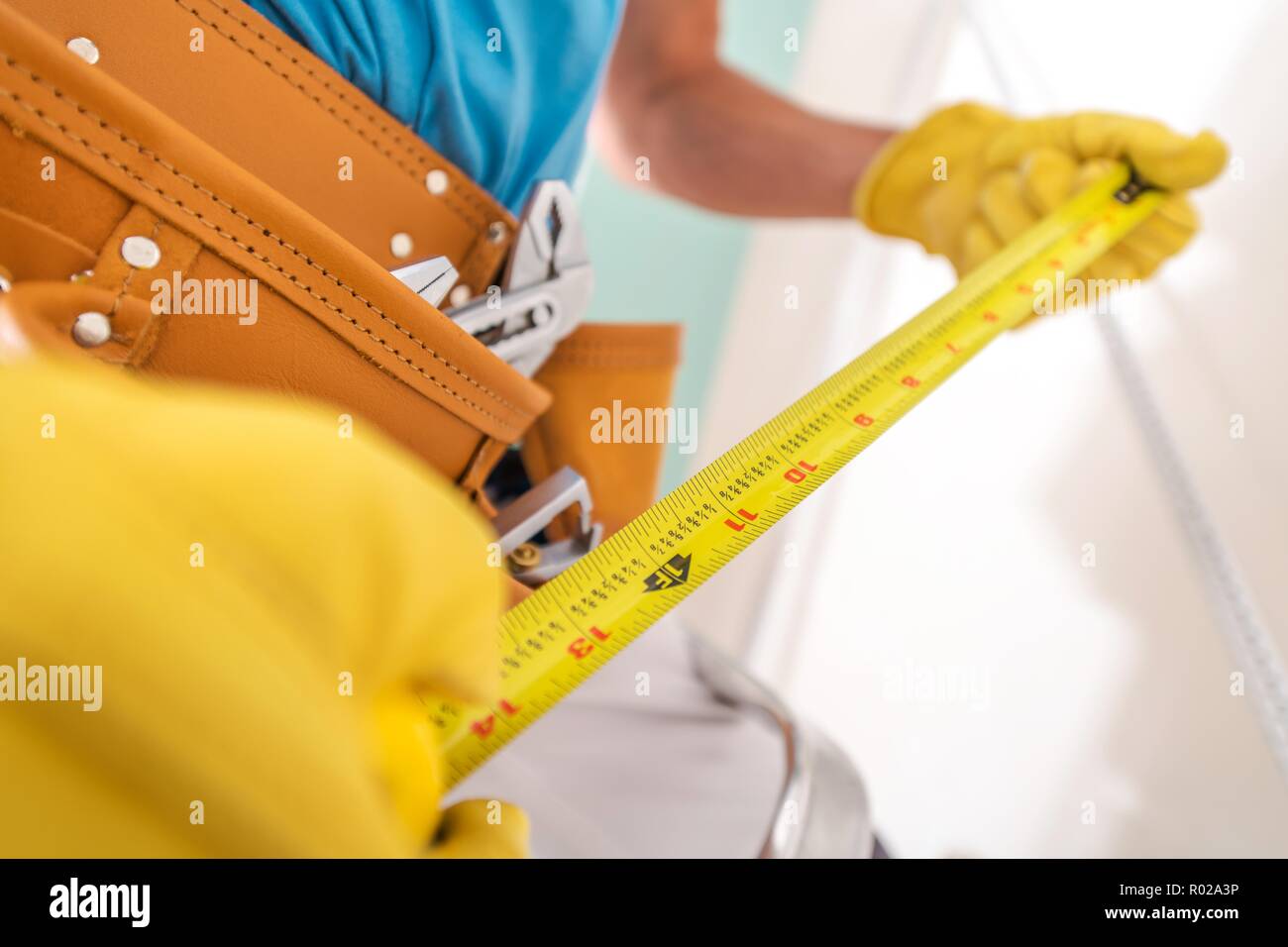 Measuring Tape in a Hand of Construction Worker Stock Photo - Alamy