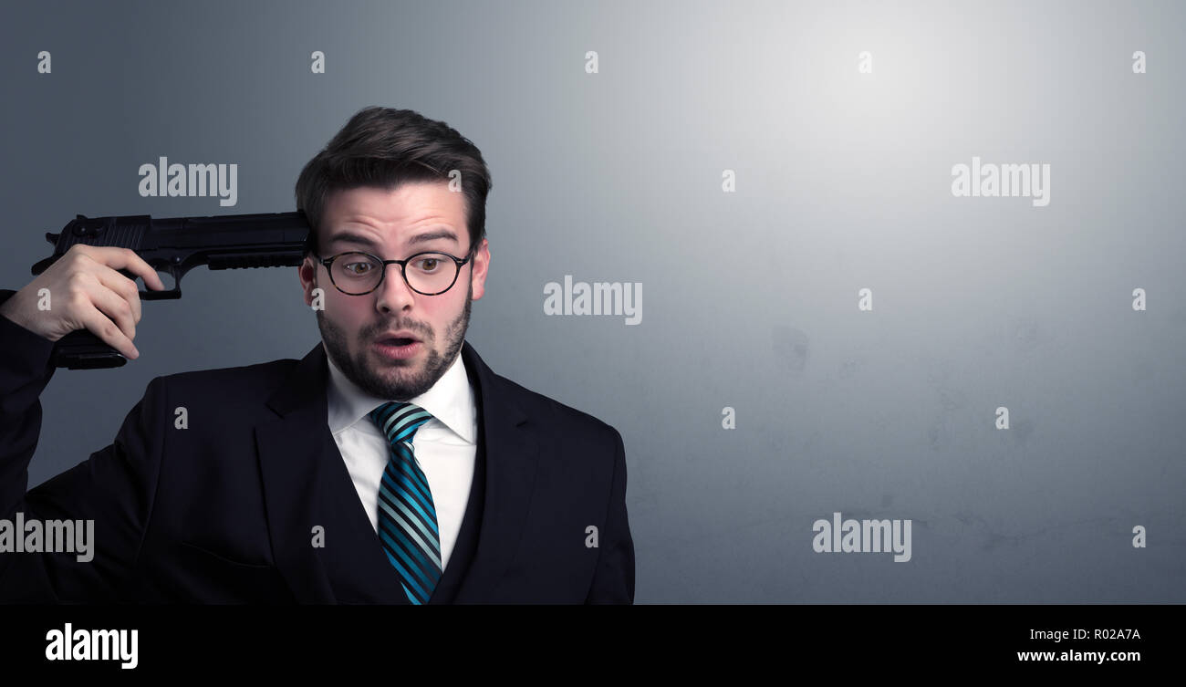 Young lost businessman man shooting his head with gun Stock Photo - Alamy