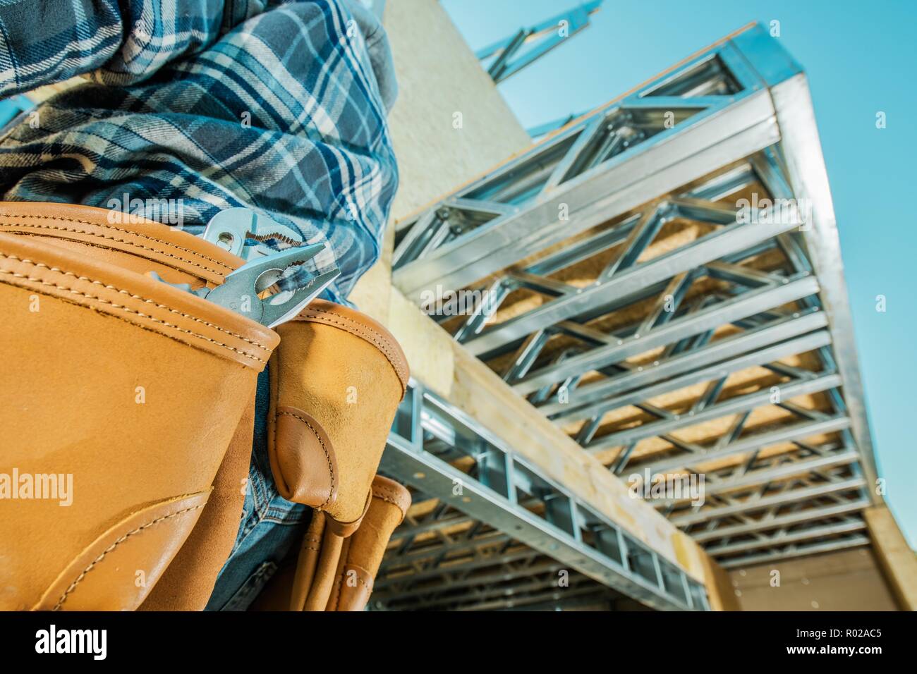 Steel Frame House Builder and His Tools Belt Closeup. Construction Site ...