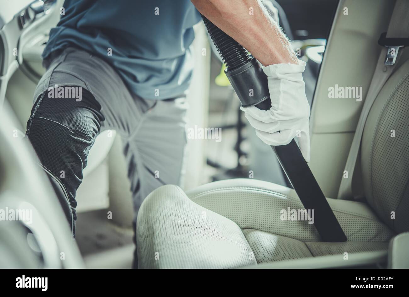 Vehicle Interior Vacuuming by Professional Caucasian Cleaner. Keeping ...