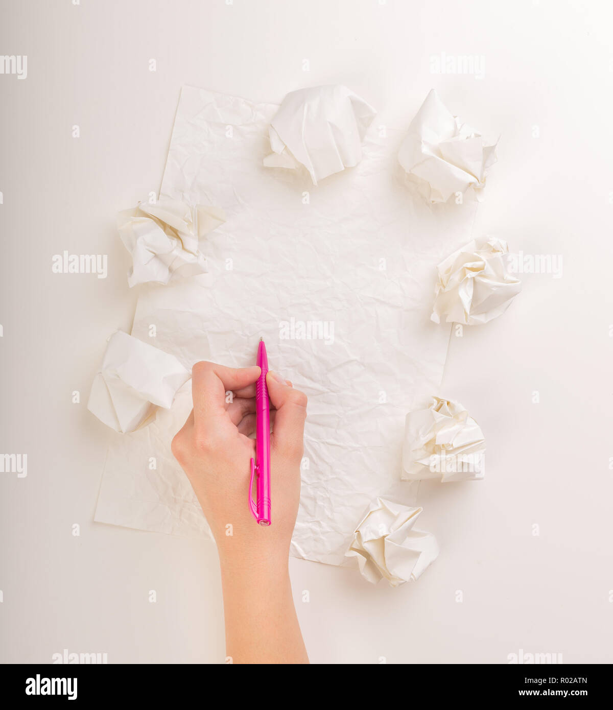 Female hand trying to write next to a few crumpled paper balls Stock ...