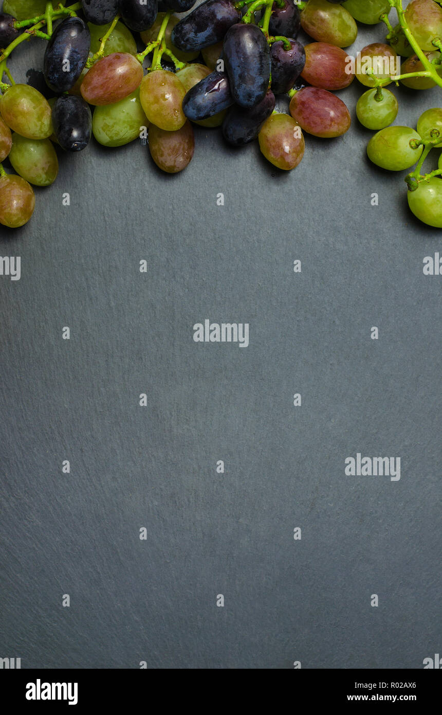 Grapes on dark background with copy space. Vertical frame Stock Photo ...