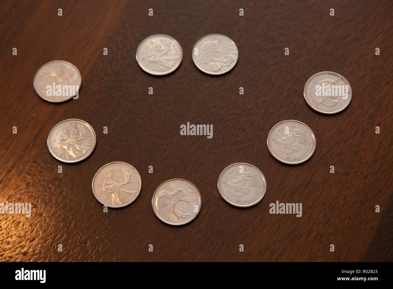 A bunch of quarters made from a happy smile on the table Stock Photo ...