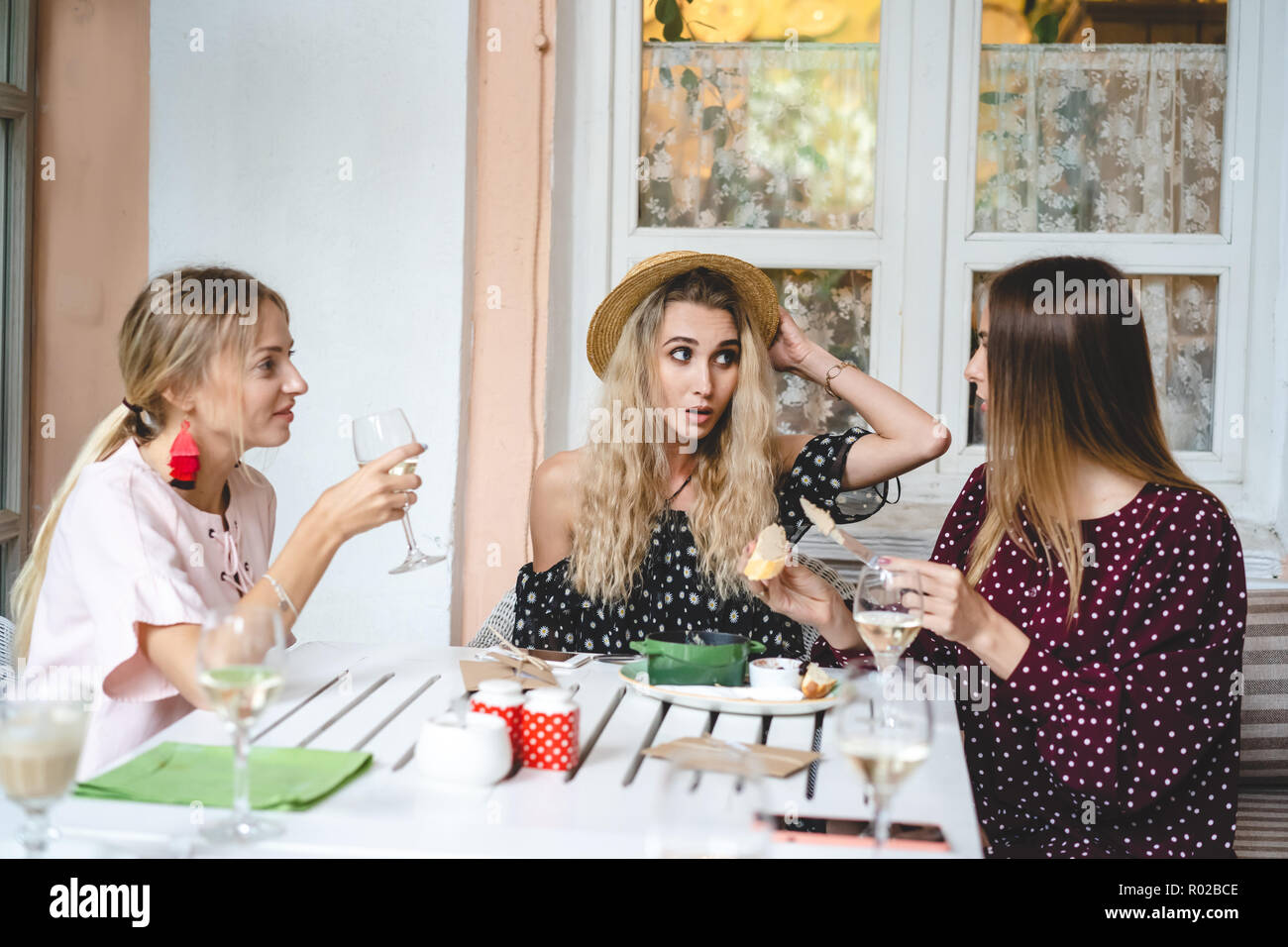 Three girls at the table Stock Photo - Alamy
