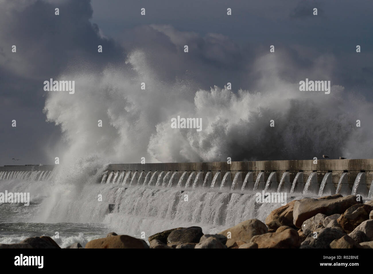 Big stormy wave splash against dark sky before rain. Douro river mouth ...