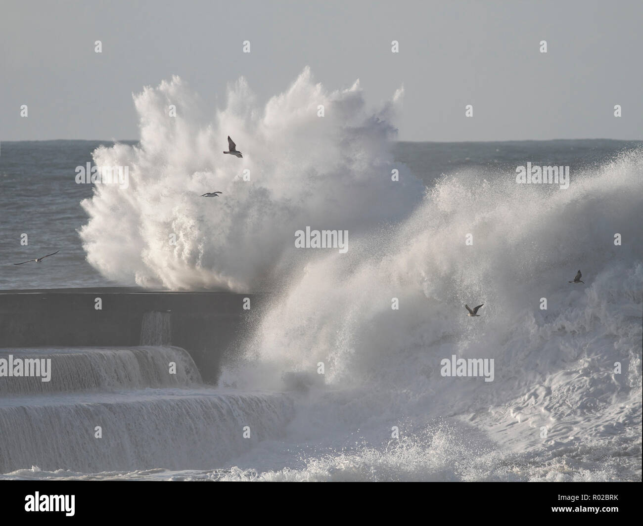 Huge splash from an Atlantic sea wave breaking over pier Stock Photo ...