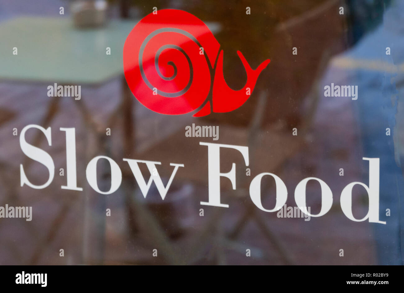A Slow Food sign on the window of a Seville restaurant. Slow Food is ...