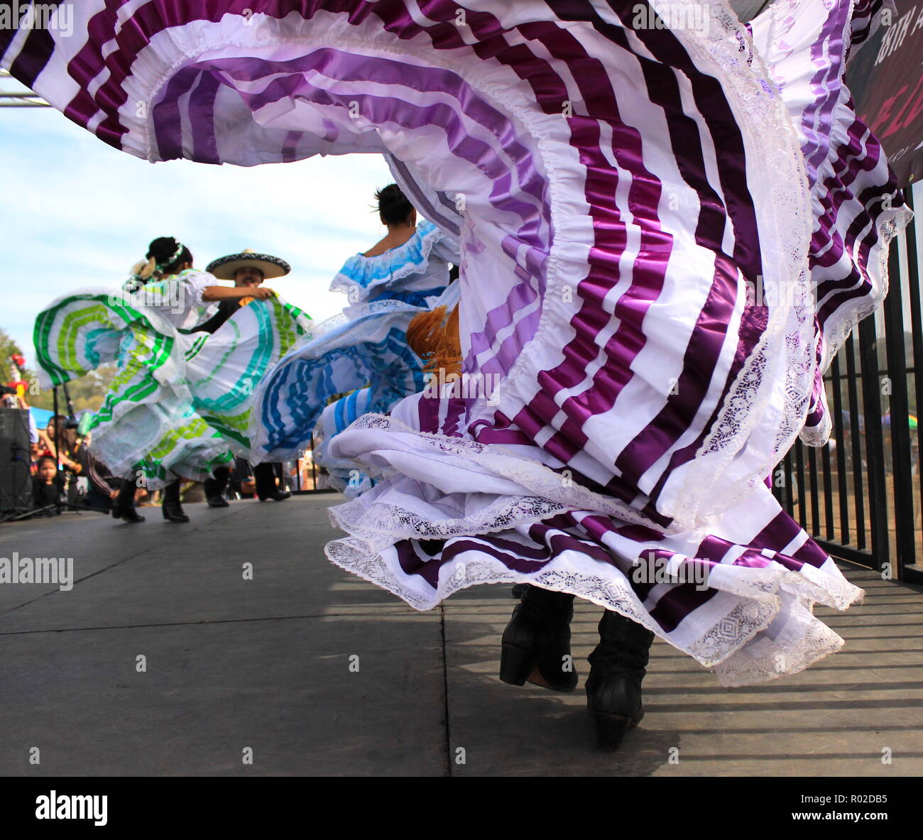 Colorful traditional dresses whirl during Mexican dance performance ...